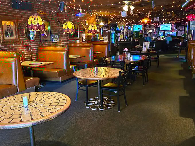 The bar area glows with amber light from vintage fixtures, while leather booths invite you to settle in for the long haul.