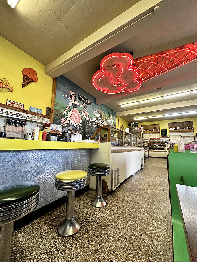 Chrome stools and yellow counters create the perfect perch for milkshake contemplation. This isn't decoration&mdash;it's time travel.