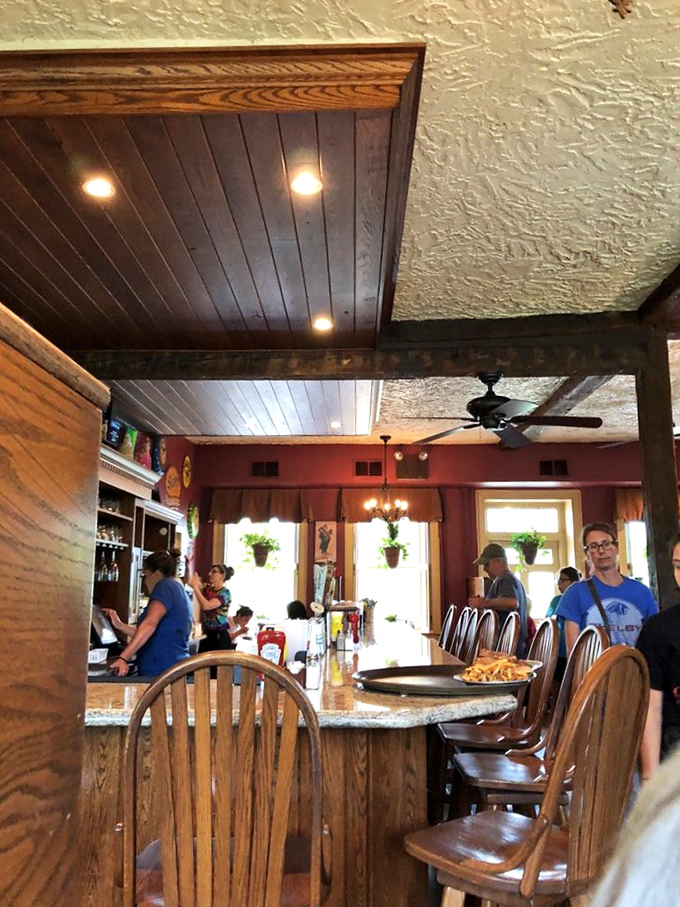 The dining room blends rustic charm with modern comfort. Those wooden ceiling beams have stories to tell, if only you'd put down your phone.