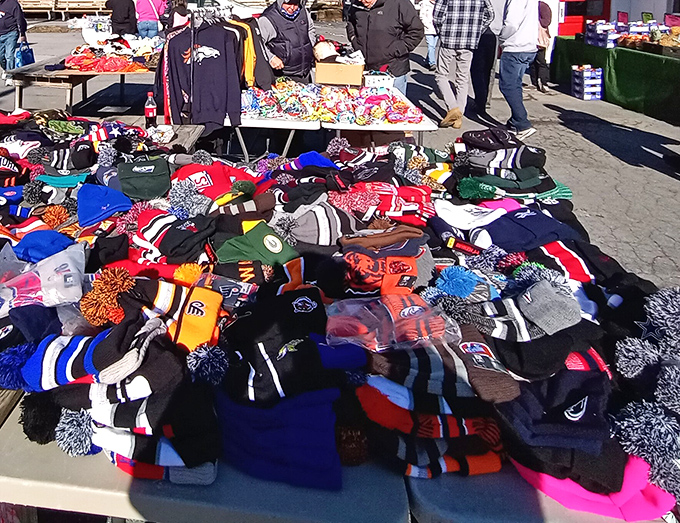 Team spirit by the pile! A mountain of sports beanies where bitter rivals peacefully coexist until separated by passionate fans.