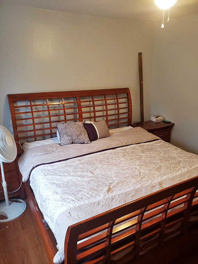 Sleek wooden bed frame that whispers "mid-century modern" without shouting "I spent my entire furniture budget on one piece."