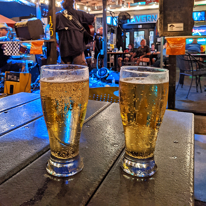 Two perfectly poured beers catching the blue glow of neon signs&mdash;a sight as beautiful to tavern-goers as a sunset is to poets.