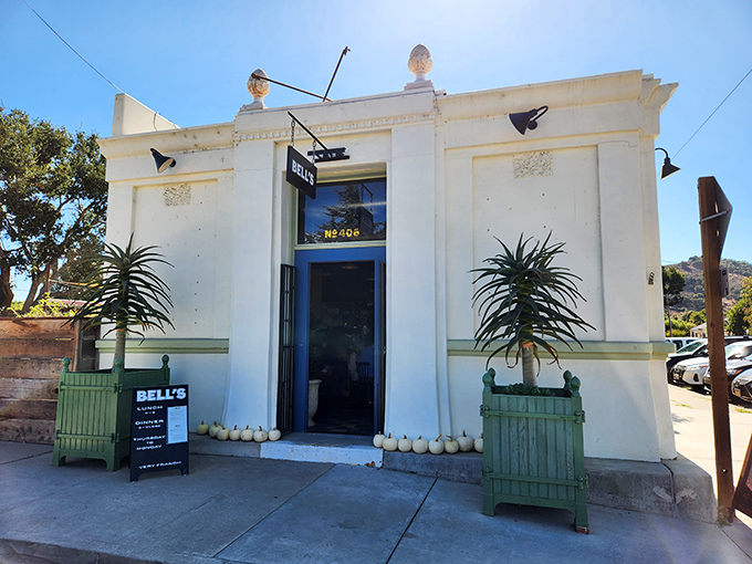 Bell's crisp white facade and mint-green planters announce its French-California pedigree with the architectural equivalent of a confident whisper.