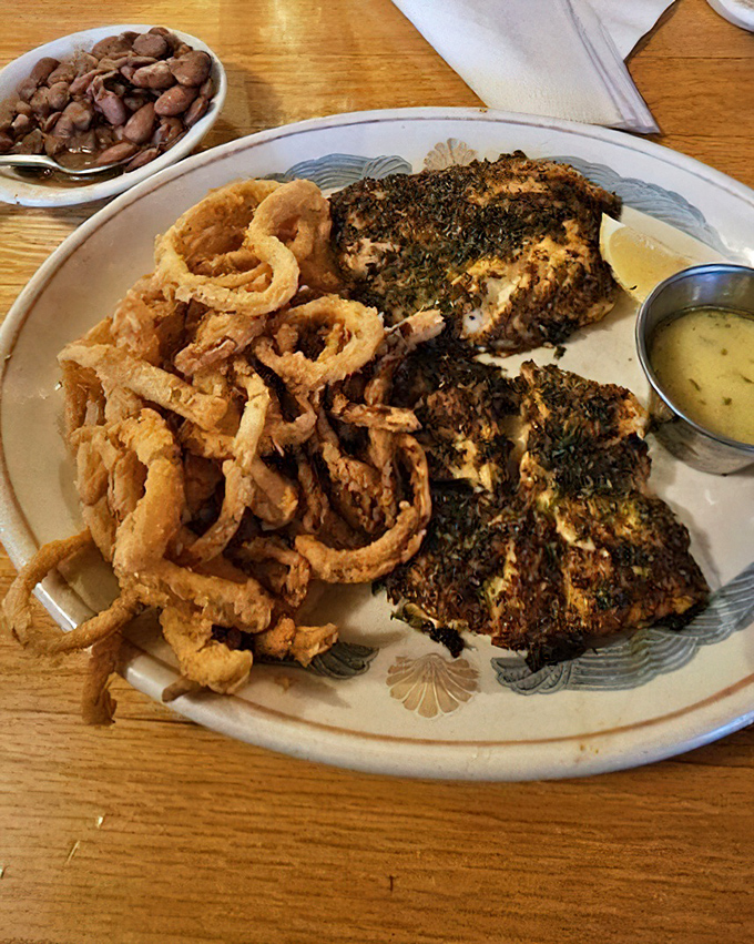 Blackened grouper with a side of those famous onion rings. A plate that proves sometimes the best seasoning is a heavy hand and no apologies.