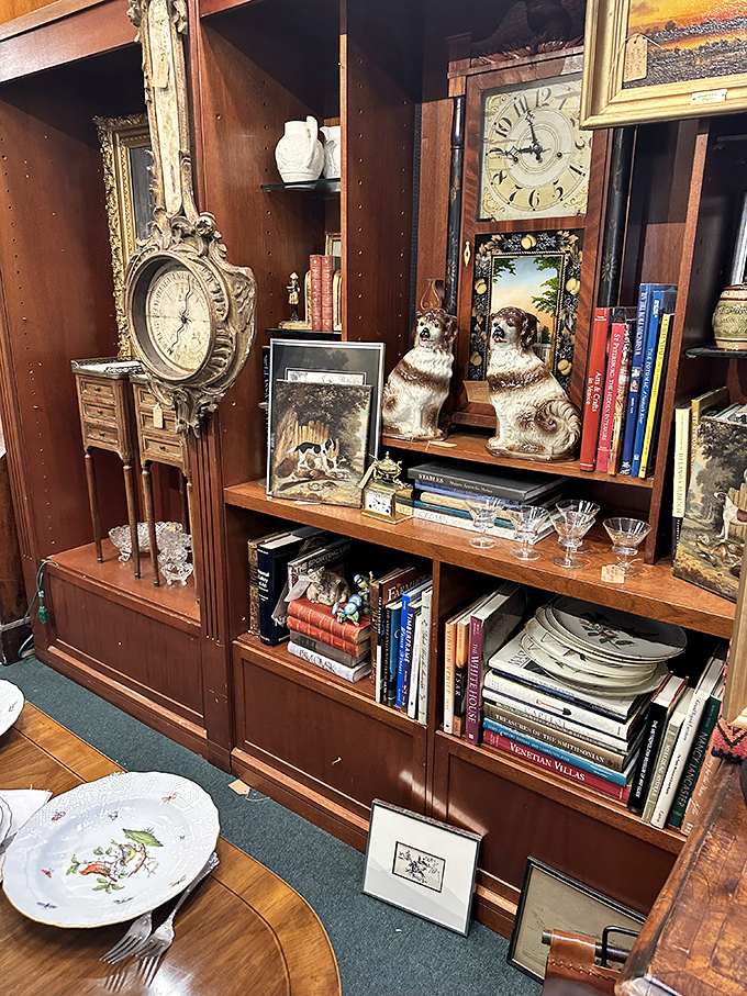 Literary treasures share shelf space with ceramic companions. Those Staffordshire dogs have guarded these books through decades of changing hands.