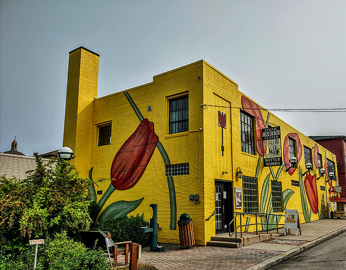 The Bottle Works building bursts with color like a flower blooming through concrete &ndash; art finding its way despite industrial roots.