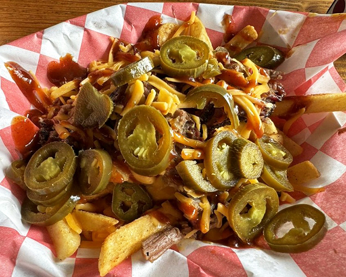 Loaded fries that turn a side dish into the main event, with jalape&ntilde;os standing guard over a treasure of cheese, meat, and sauce.