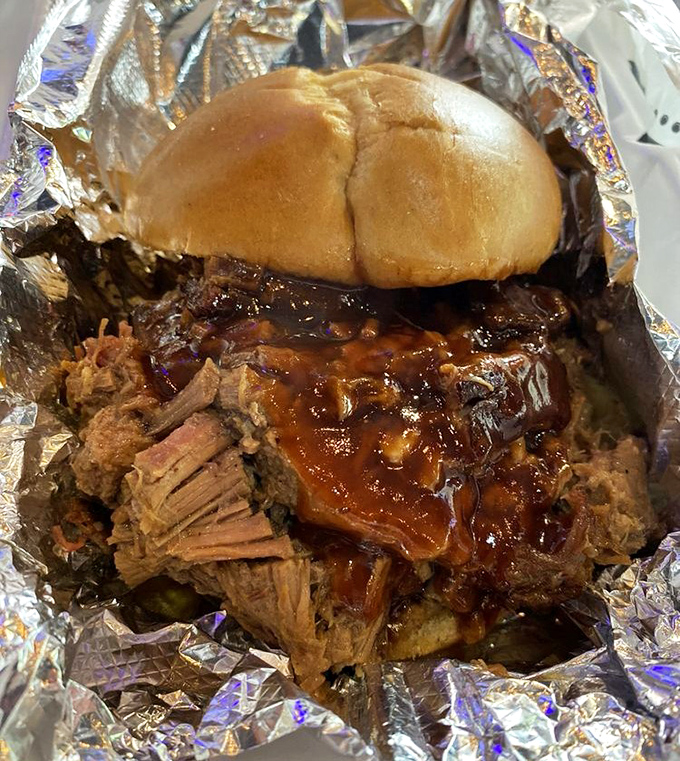 A brisket sandwich that requires both hands, several napkins, and a moment of silent appreciation before the first magnificent bite.