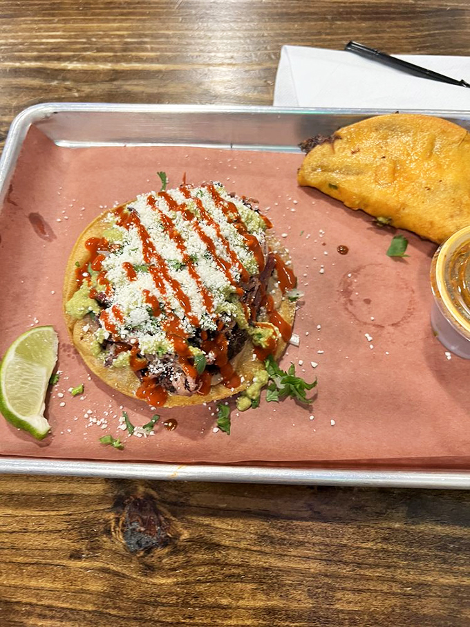 The brisket tostada proves that great barbecue transcends borders, creating a cross-cultural masterpiece that demands to be devoured.