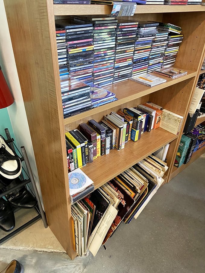 Media nostalgia by the shelf-full! CDs, DVDs, and books create a time capsule of entertainment that predates streaming but never goes out of style.