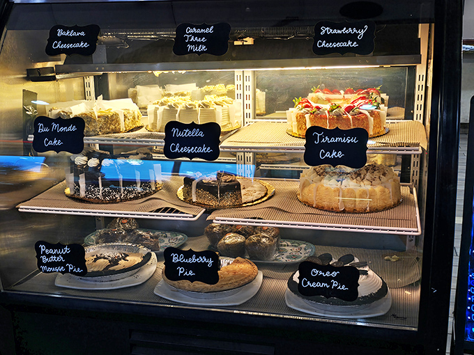 The dessert case &ndash; a glass-enclosed museum of temptation where willpower goes to die. That tiramisu is practically winking at you. 