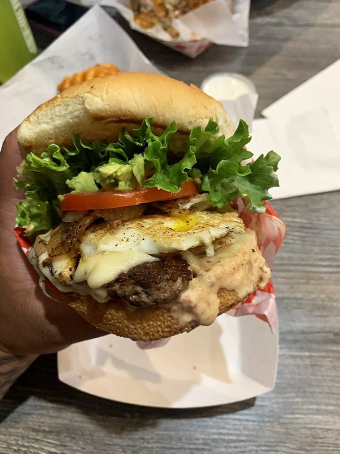The California burger, where avocado meets beef in a match made in Golden State heaven. That sauce seeping into the bun is pure joy.