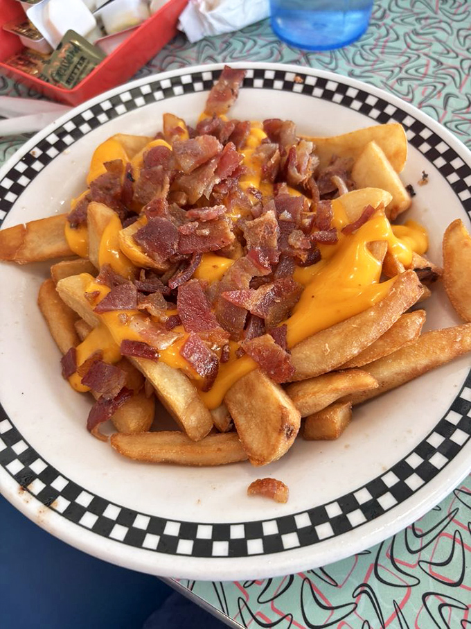 Cheese fries with bacon bits&mdash;where diet plans go to die and nobody's sorry about it. Worth every delicious calorie.