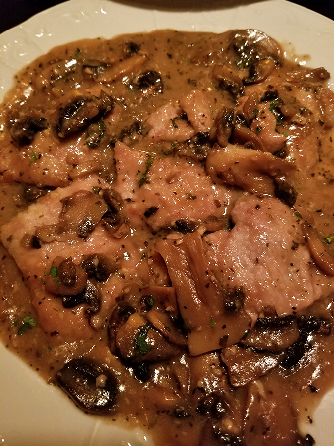 Veal Marsala arrives swimming in a mushroom-studded sauce so rich it should have its own zip code and tax bracket.