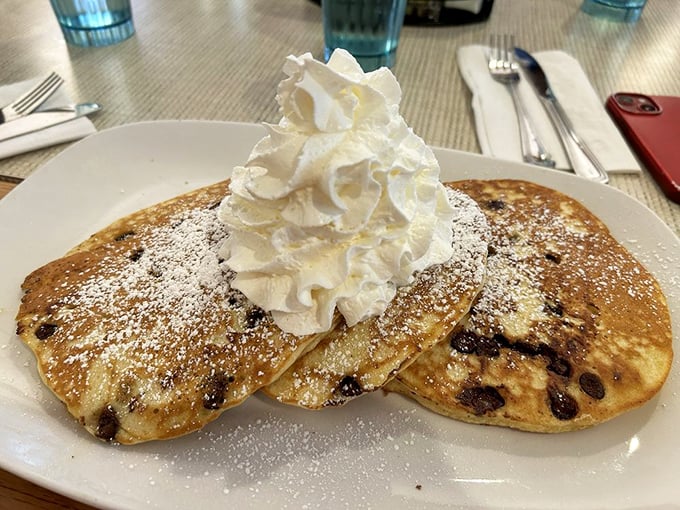 Chocolate chip pancakes with a whipped cream mountain on top—breakfast's answer to "Why wait for dessert?"