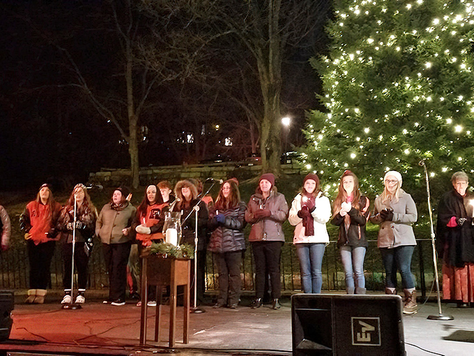 Evening carolers gather under twinkling lights, transforming the village into a Victorian Christmas card come to life.