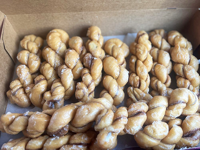 These twisted cinnamon treats look like they're doing synchronized swimming in a pool of glaze—Olympic gold medal material.
