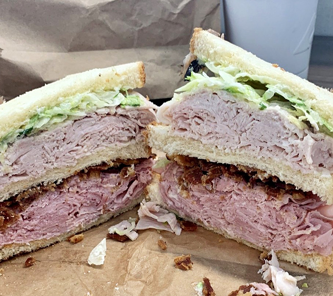 When a club sandwich stands this tall, it's not just lunch – it's an achievement, a monument to the understanding that more good things are indeed better.