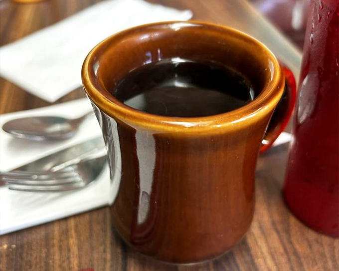 That brown ceramic mug isn't just holding coffee&mdash;it's holding the fuel that's powered American dreams and morning deadlines for generations.