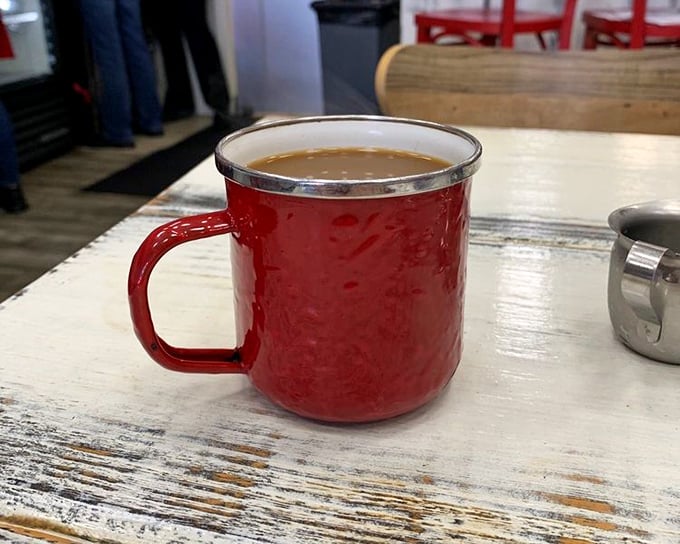 Coffee served in a red enamel mug&mdash;simple, unpretentious, and exactly right. The kind of cup that makes Monday mornings slightly more bearable.