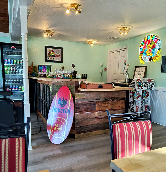 The bar area combines beach-town casual with rustic charm. That surfboard isn't just decoration&mdash;it's a reminder you're dining in a slice of Florida paradise. 