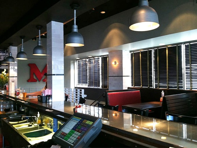 Clean lines, industrial lighting, and that bold red "M"&mdash;Mercury's counter area blends modern efficiency with classic burger joint charm.