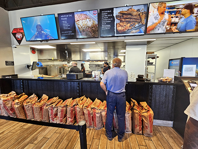 The ordering counter: where hopes rise and hunger pangs begin their final countdown. Those bags of charcoal aren't decoration—they're the fuel of legends.