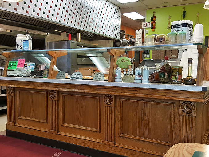 The command center where culinary miracles happen daily, complete with glass cases displaying tomorrow's happiness in waiting.