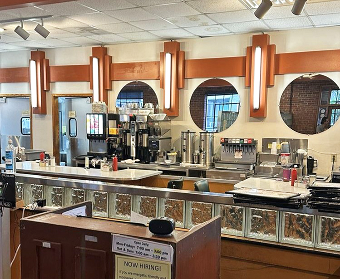 The beating heart of any great diner&mdash;a counter setup that's part coffee bar, part command center, with those distinctive round mirrors adding retro charm.