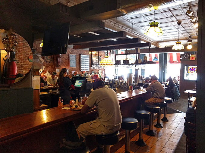 The counter seating: where solo diners become regulars and regulars become family. Notice the comfortable slouch of contentment on every patron.