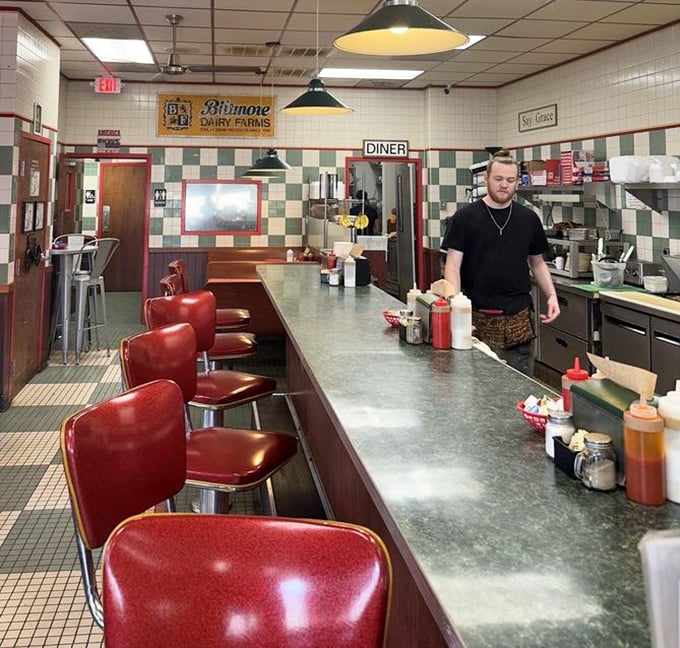 Those red counter stools have witnessed countless conversations, confessions, and coffee refills. Silent sentinels of Asheville's morning rituals.