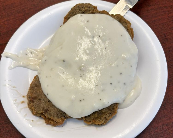 Country fried steak swimming in gravy &ndash; the kind of plate that makes cardiologists nervous and customers happy.