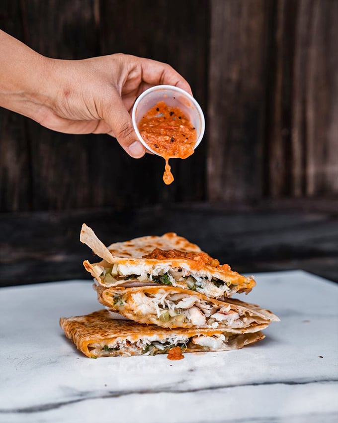 That sauce cascading over seafood quesadilla triangles isn't just condiment&mdash;it's liquid excitement, promising flavors that'll make your taste buds stand up and applaud.