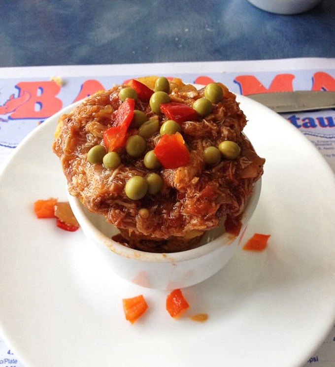 Tostones rellenos crowned with savory crab &ndash; the Caribbean's answer to the loaded potato. Two culinary traditions collide in delicious harmony.