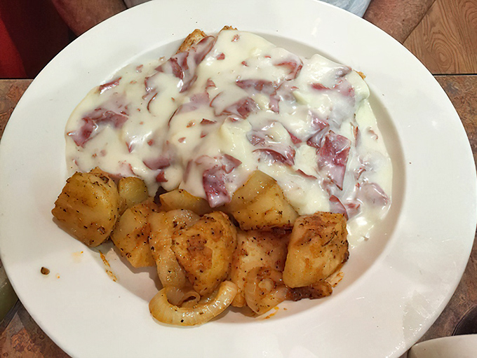 Creamed chipped beef: the dish that sustained a generation. Silky cream sauce blankets savory beef while potatoes wait patiently for their turn.