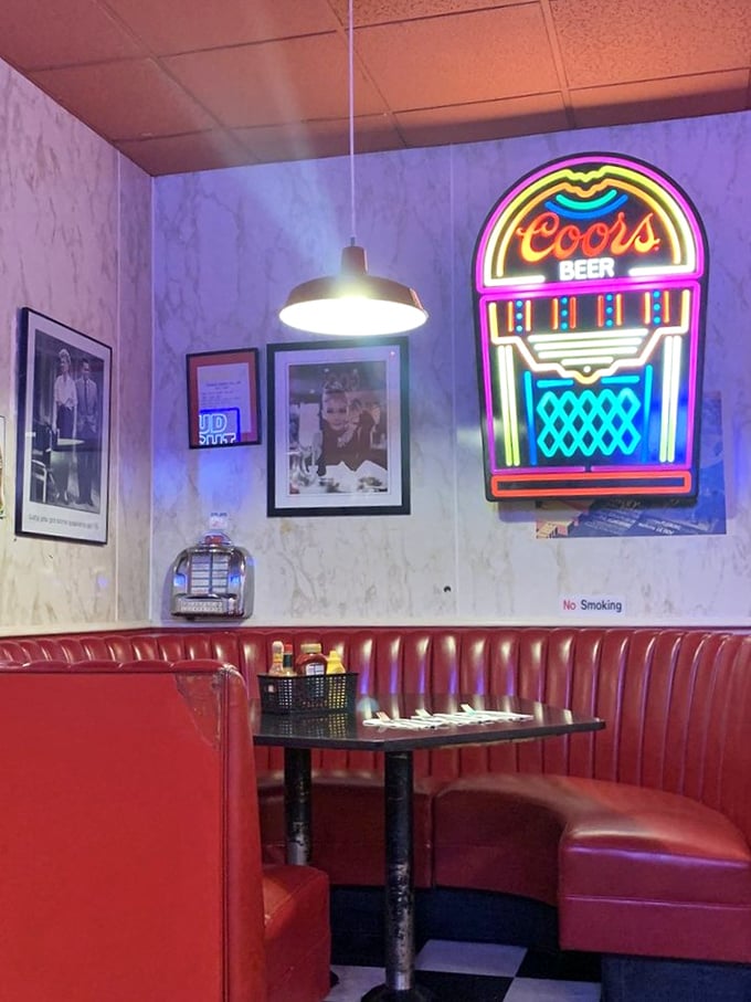 The neon glow isn't just lighting—it's a beacon for hungry souls. That booth has heard more life stories than most therapists.