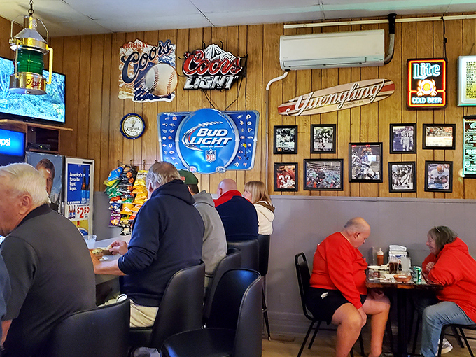 Beer signs and sports memorabilia create the perfect backdrop for serious sandwich consumption.