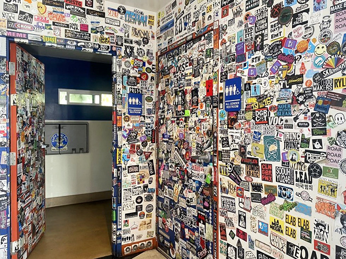 Every inch of wall space tells a story at Rudy's, where band stickers and memorabilia create a visual history of punk rock culture.