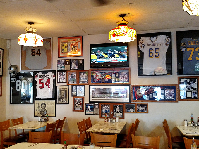 Sports memorabilia and local history cover the walls, creating not just decoration but a community archive where every framed jersey tells a story.