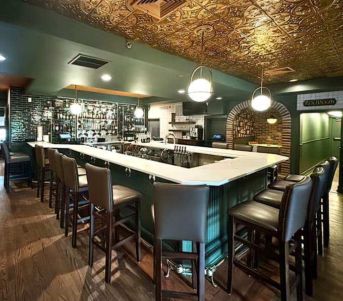 The bar's ornate ceiling tiles and elegant counter create the perfect stage for both first-date nervousness and anniversary toasts twenty years later.