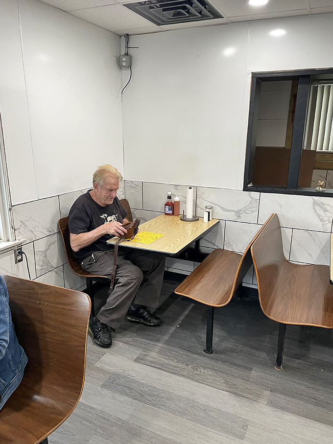 Where regulars become family. This cozy corner booth has witnessed countless conversations, celebrations, and first bites of legendary chicken.