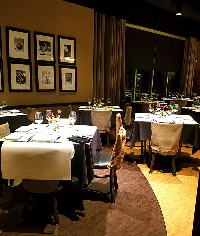 Elegant table settings beneath soft lighting create that "I'm-somewhere-special" feeling that makes ordinary Wednesdays feel like celebrations.