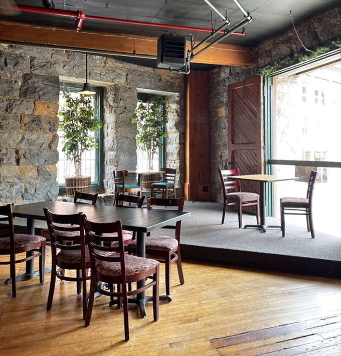 Stone walls and wooden floors tell stories of the building's industrial past, while comfortable seating promises a very pleasant present.