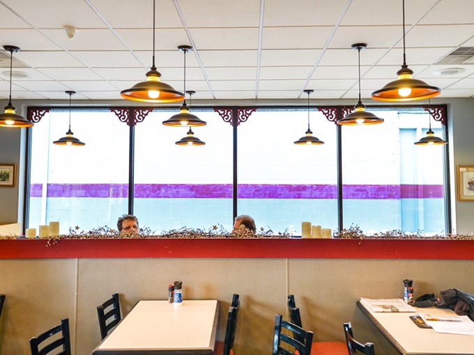 Simple tables, pendant lights, and soon-to-be-sticky fingers. The dining area is designed for one purpose: focused appreciation of baked perfection.