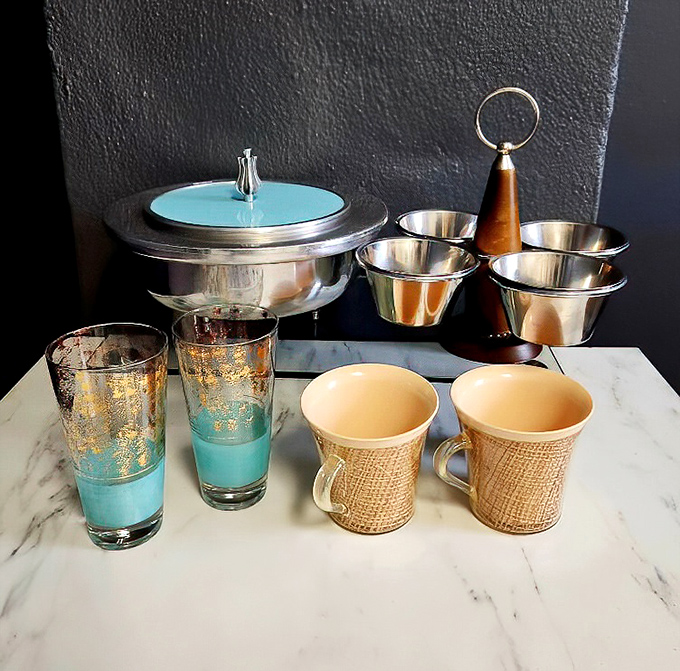 Mid-century modern meets retro kitsch in this dishware collection. Those turquoise glasses are practically begging to hold your next cocktail creation
