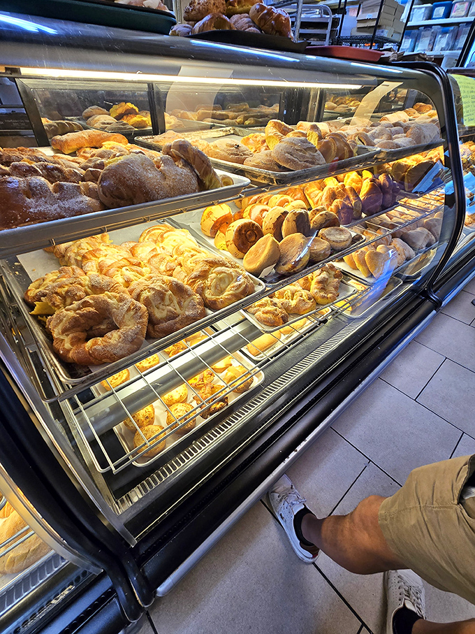 This bakery case isn't just displaying bread&mdash;it's showcasing edible art forms that have been perfected over generations and somehow still cost less than your fancy coffee.