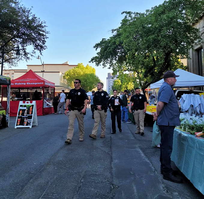 Local law enforcement strolls through the downtown market, ensuring the only thing stolen is a recipe idea for tonight's farm-fresh dinner.