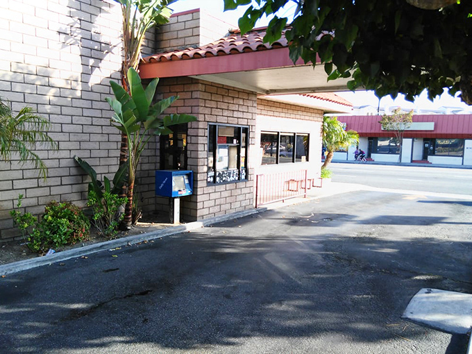 Even the drive-thru area maintains that classic California charm with palm trees standing guard over countless quick burger missions.