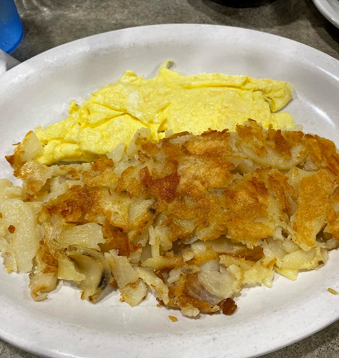 The perfect diner breakfast duet &ndash; eggs sunny and bright alongside home fries that have achieved that mythical balance of crispy exterior and fluffy interior.