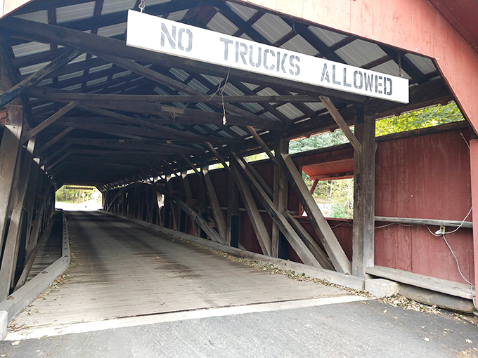 The entrance beckons like a portal to simpler times. That "NO TRUCKS" warning is the 19th century equivalent of "mind your head."